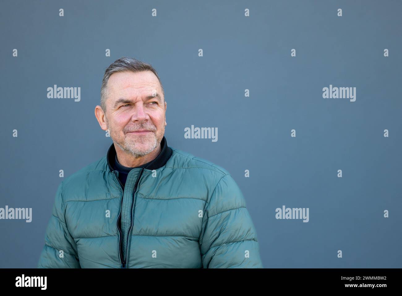 Upper body portrait of a middle aged man looking sideways into the ...