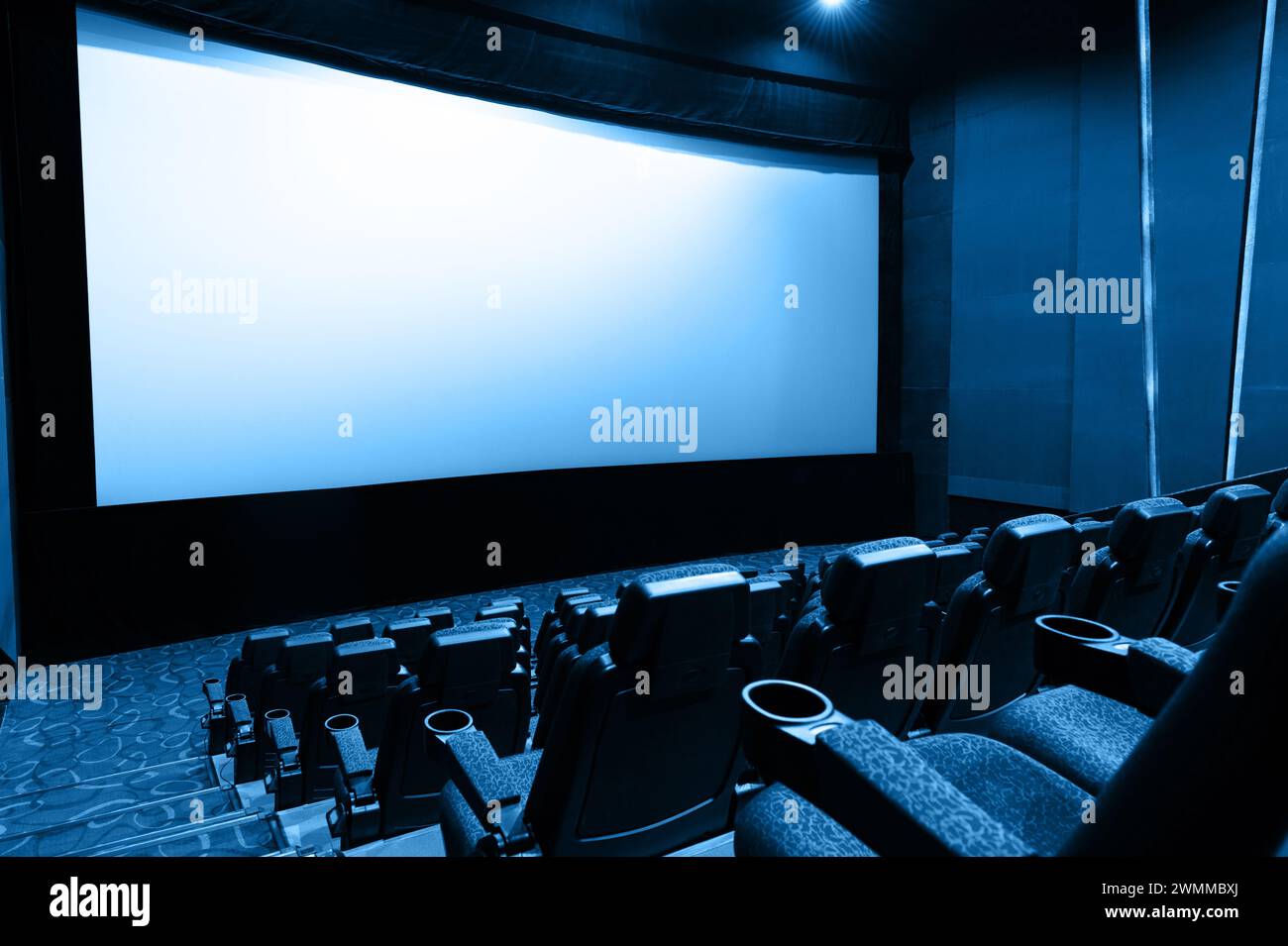 Dark movie theatre interior with screen and chairs Stock Photo - Alamy