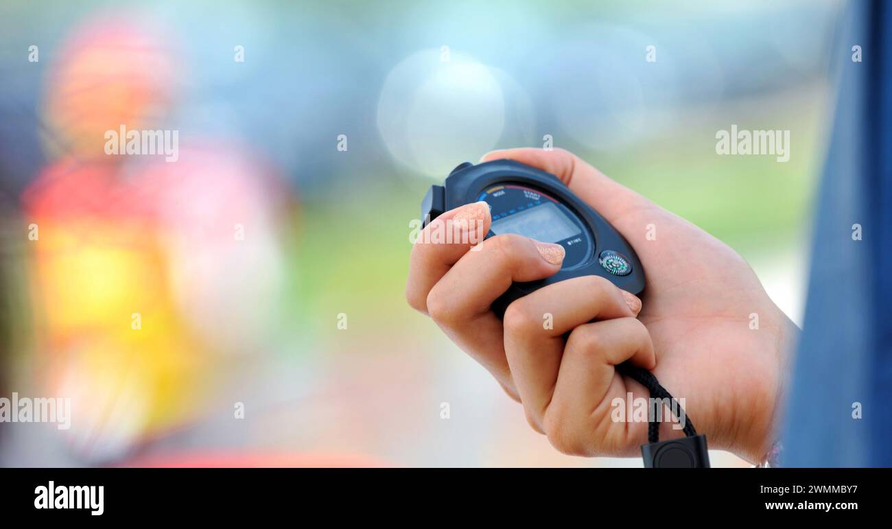 Hand holding the running stopwatch Stock Photo - Alamy