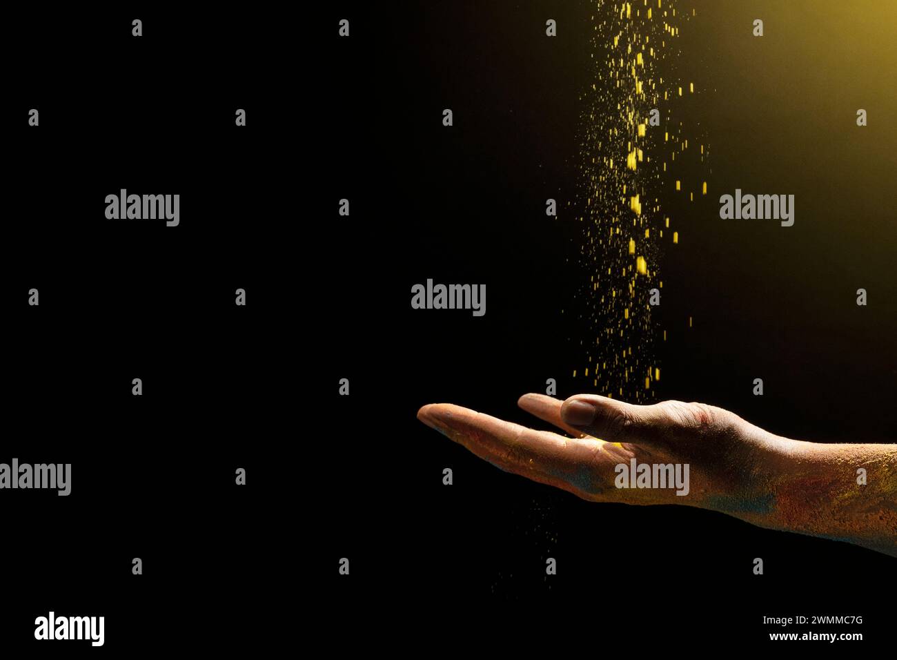 Human hand with colorful Holi powder on a black background. Holi ...
