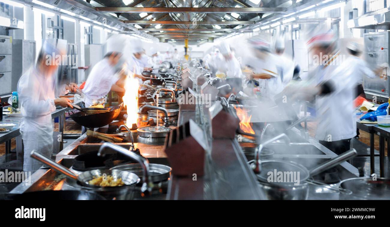 Motion chefs working in Chinese restaurant kitchen Stock Photo - Alamy