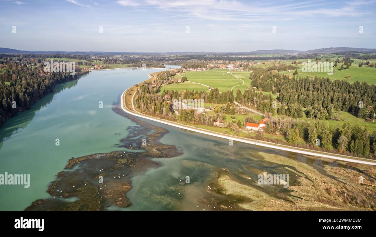 An aerial view of a river flowing through lush greenery and rolling ...