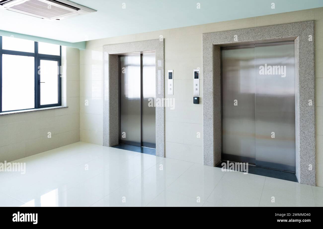 Modern steel elevator cabins in a business lobby Stock Photo - Alamy