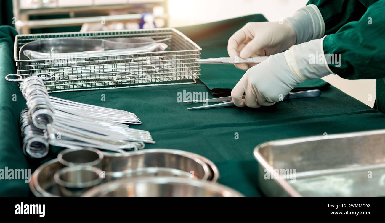 Medical instruments with surgeons hand Stock Photo - Alamy