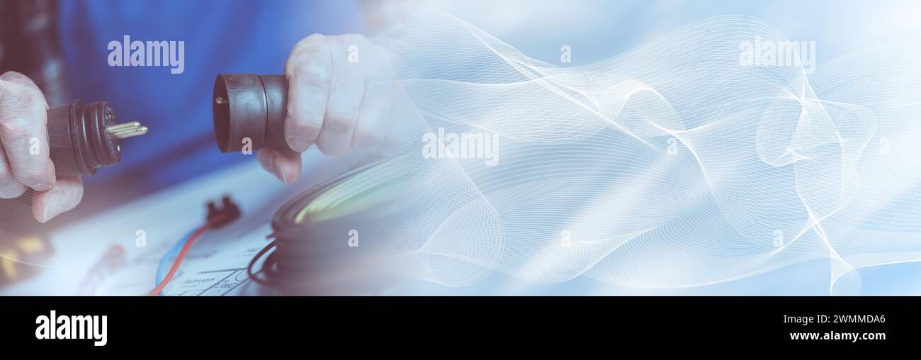 Electrician hands holding electrical plugs; panoramic banner Stock ...