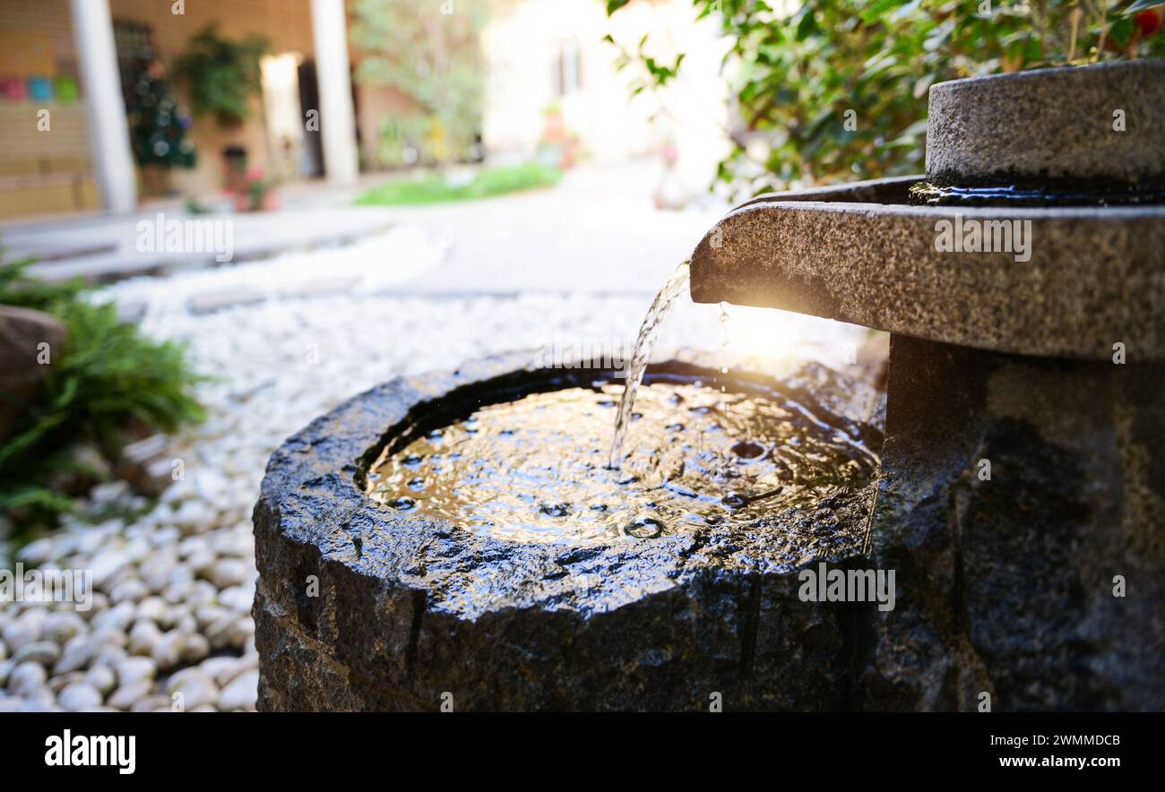 Traditional spring water fountain in garden Stock Photo - Alamy