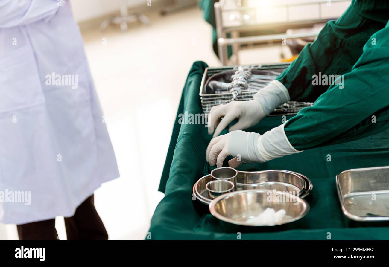 Medical instruments with surgeons hand Stock Photo - Alamy