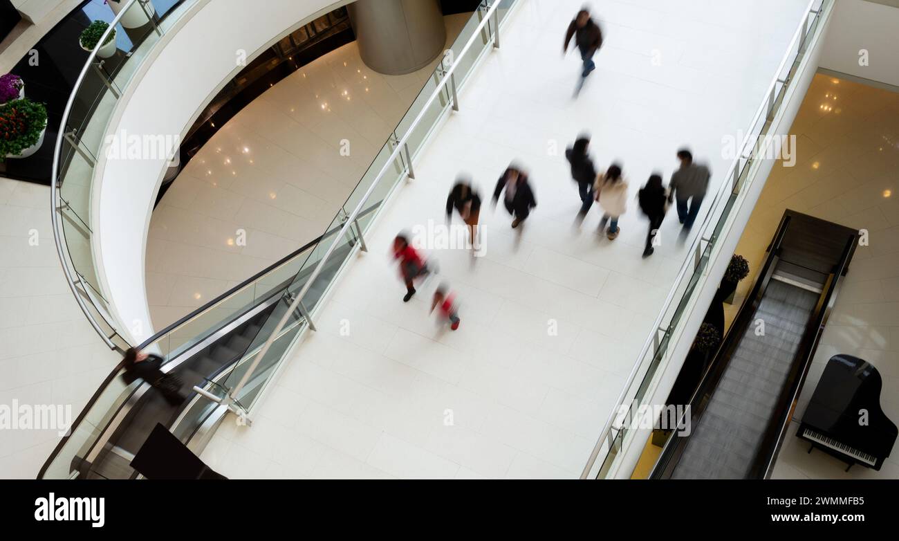 People walking in motion at modern shopping mall Stock Photo - Alamy