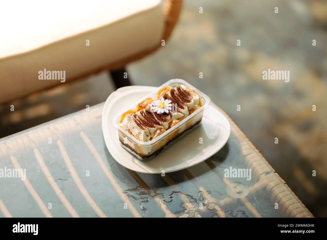 Banoffee in a clear plastic cup on a glass table in a coffee shop Stock ...