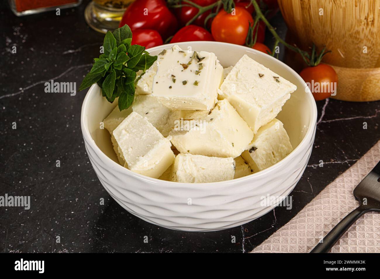 Greek traditional Feta cheese cubes with herbs and spices Stock Photo ...