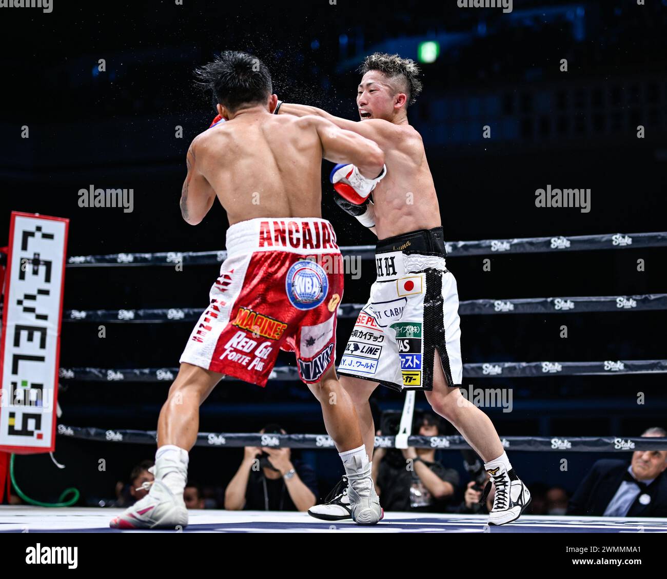 Champion Takuma Inoue (black gloves) of Japan and challenger Jerwin ...