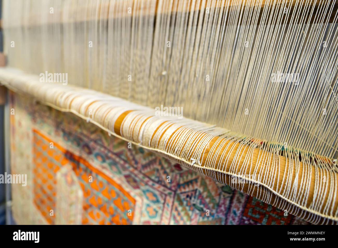 A traditional rug being woven on a carpet vertical loom, showing wool ...