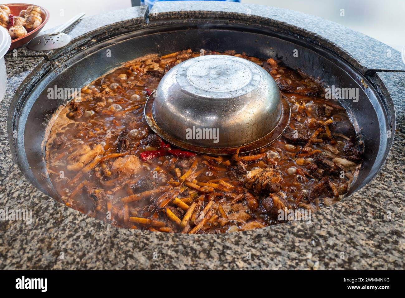 Cooking of plov in the Kazan, cauldron at the Central Asian Plov Centre ...