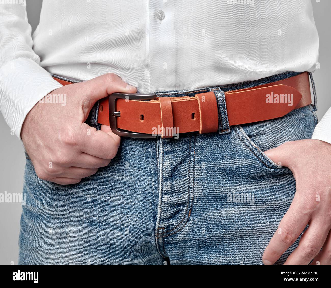 Man wearing white shirt and blue jeans with custom copper-colored ...