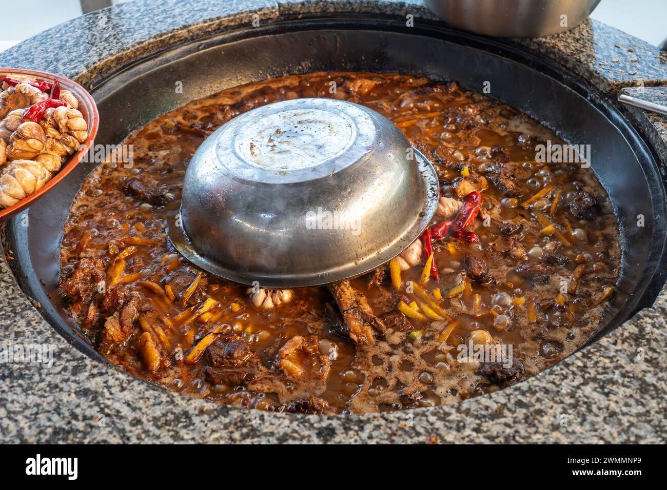 Hot pilaf in large cauldron outdoors. Traditional oriental food. Street ...