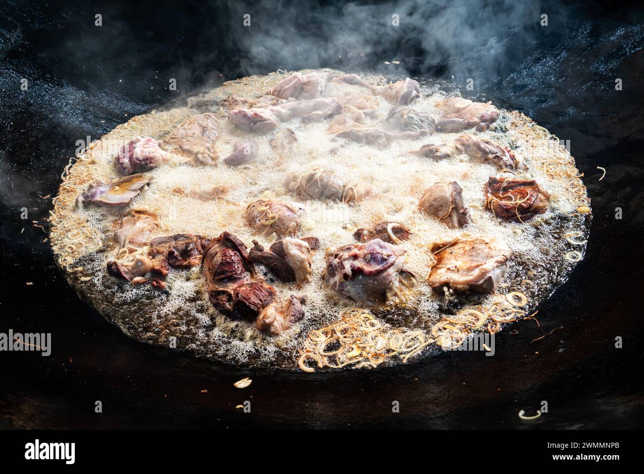 Cooking of plov in the Kazan, cauldron at the Central Asian Plov Centre ...