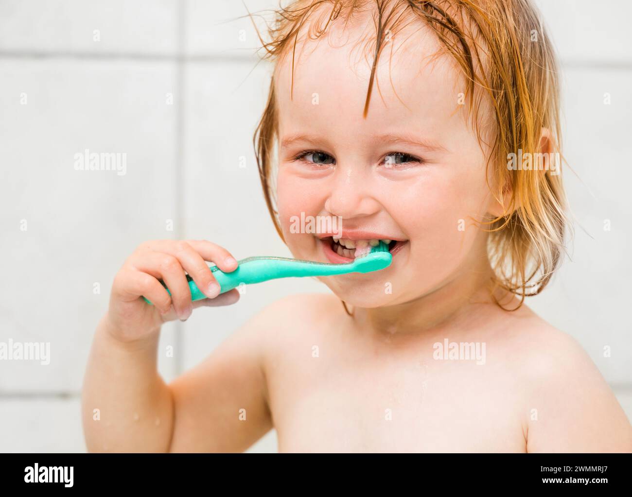 Dental hygiene. Cute baby brushing teeth in bathroom Stock Photo - Alamy