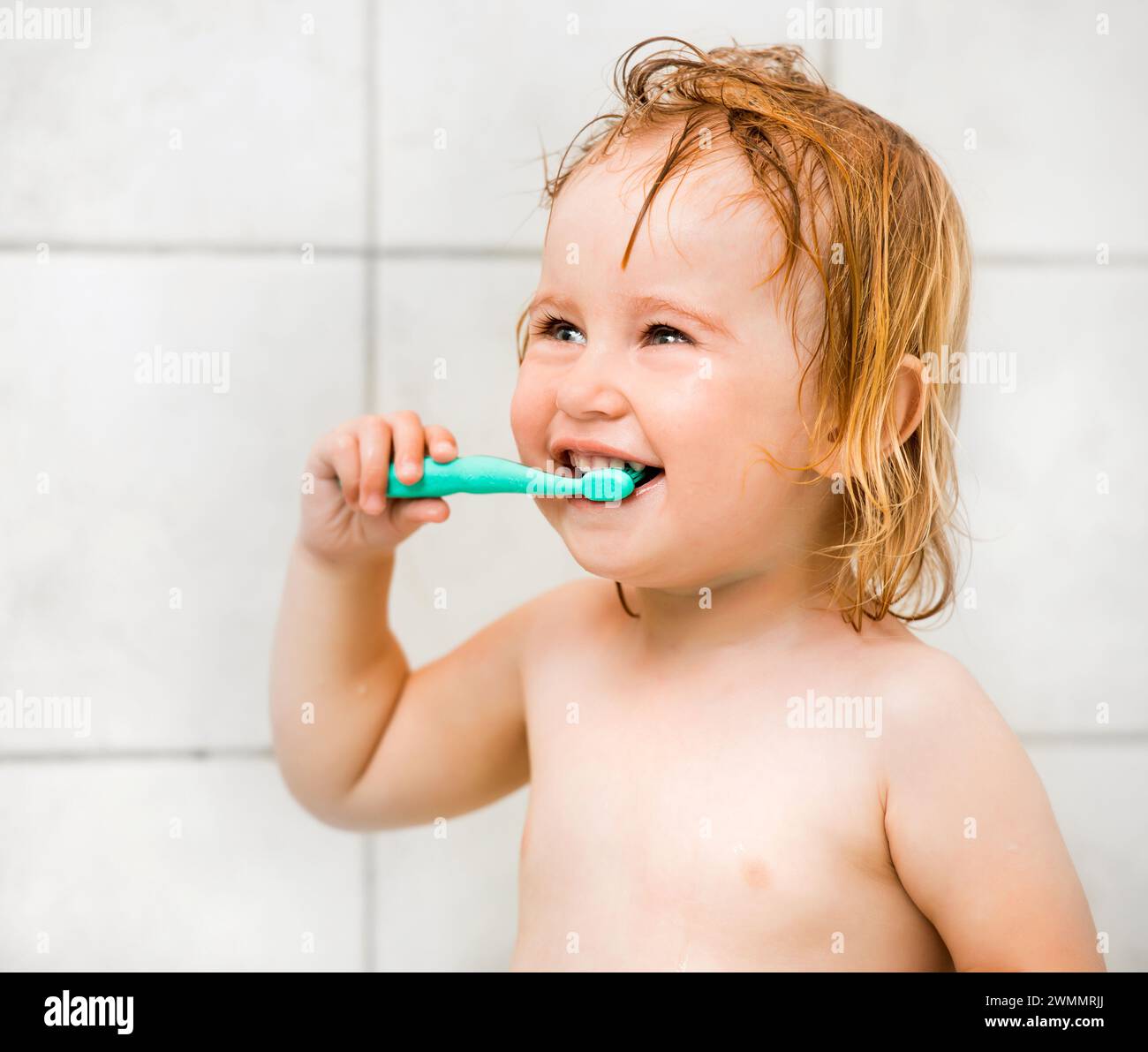 Dental hygiene. Cute baby brushing teeth in bathroom Stock Photo - Alamy