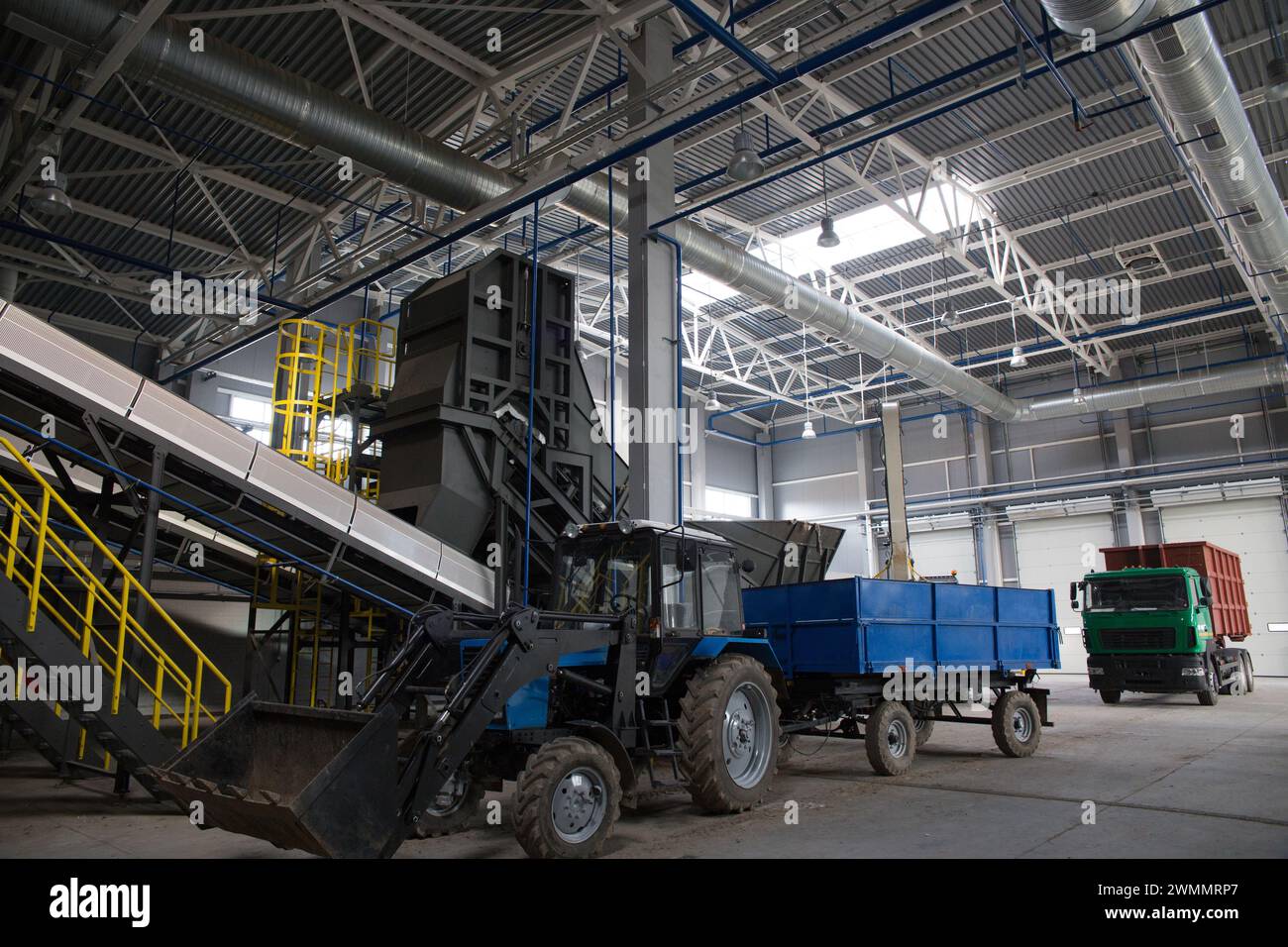 A tractor with a trailer for transporting sorted garbage and a dump ...
