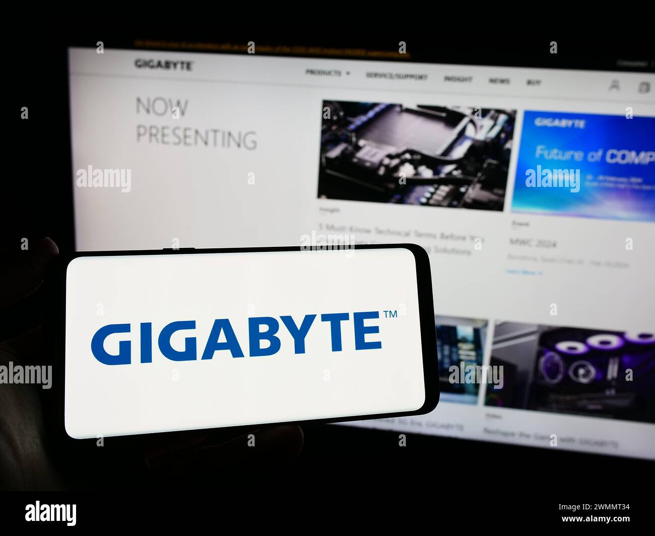 Person holding mobile phone with logo of Taiwanese computer hardware ...