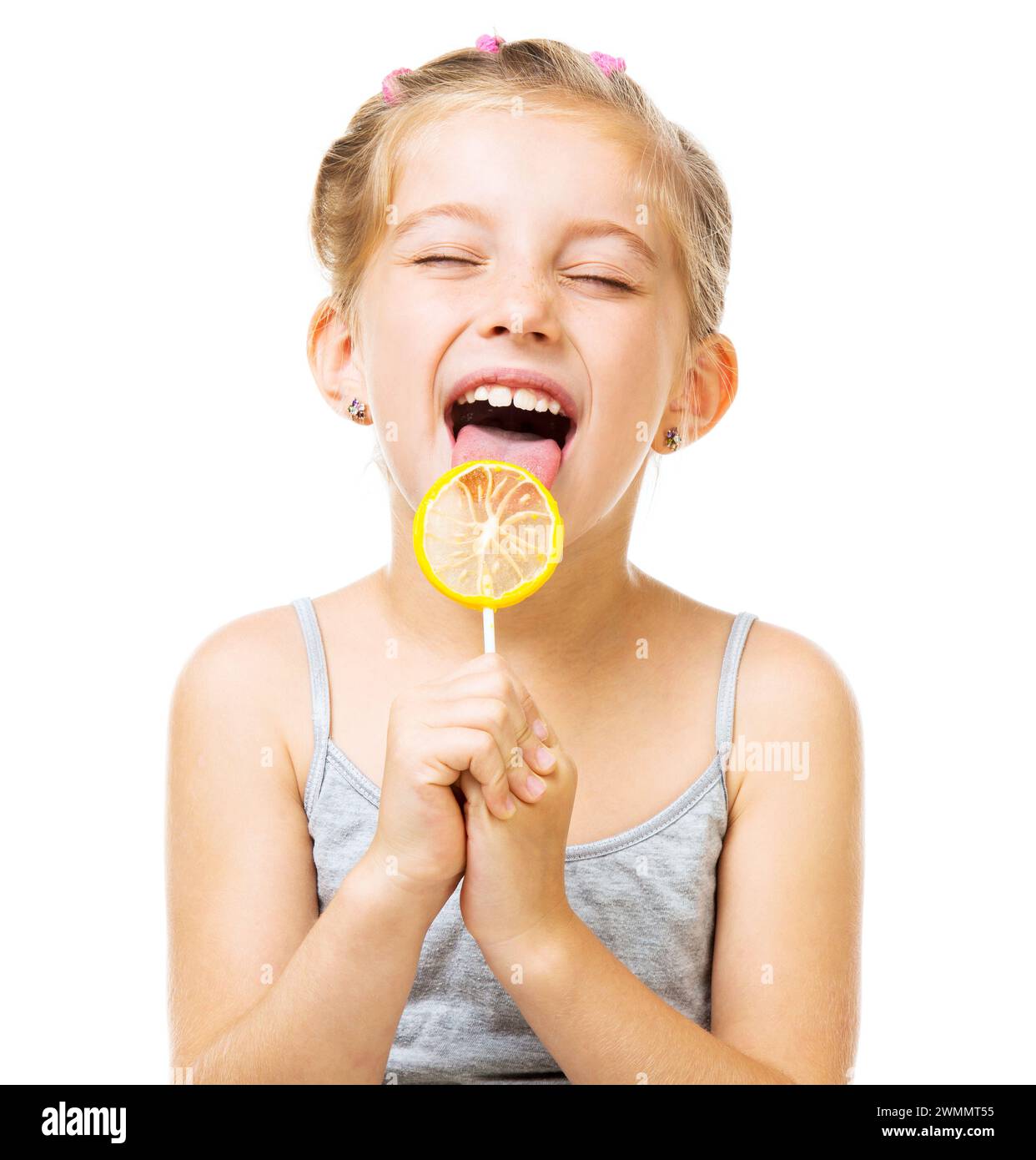 Adorable little girl with yellow lemon lollipop isolated over white ...