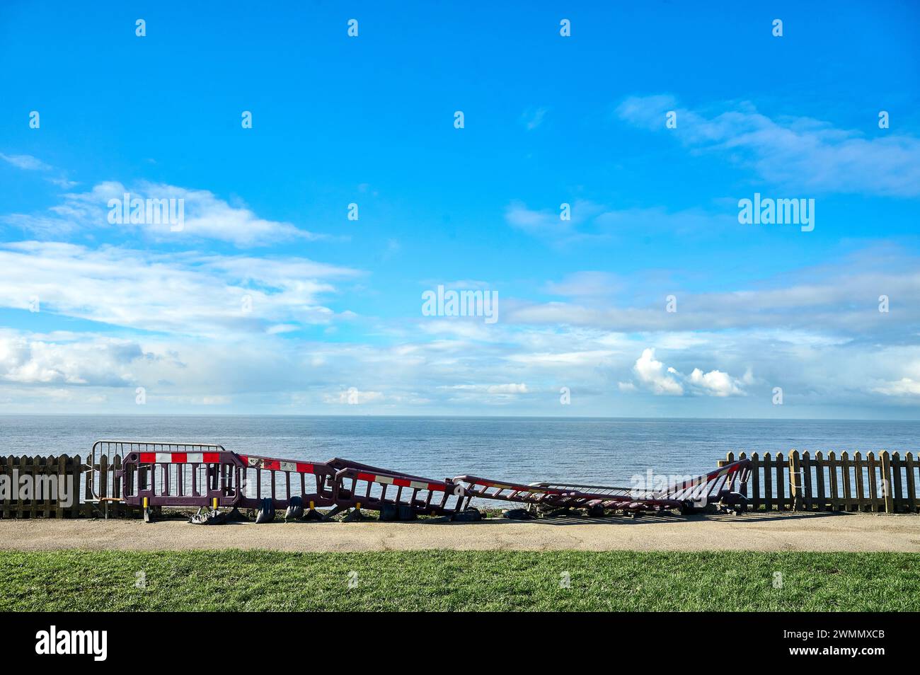 Damaged fence on cliff edge Stock Photo - Alamy