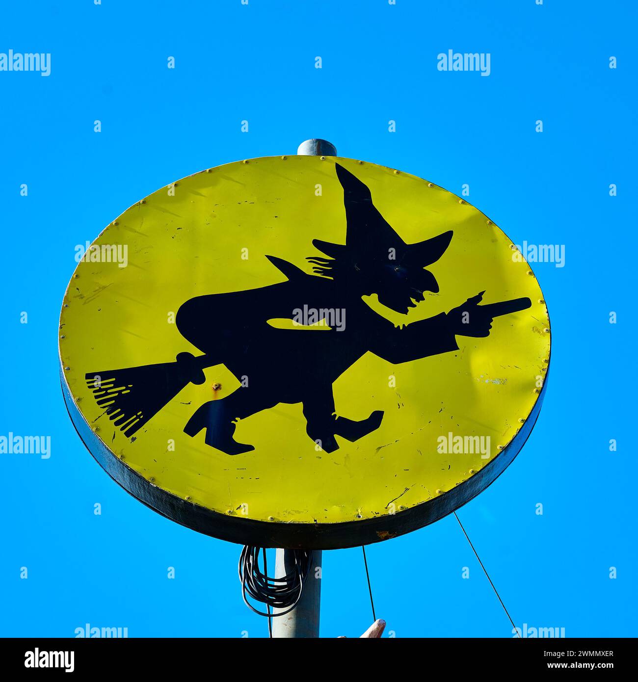 Warning high flying witches on broomsticks sign Stock Photo - Alamy