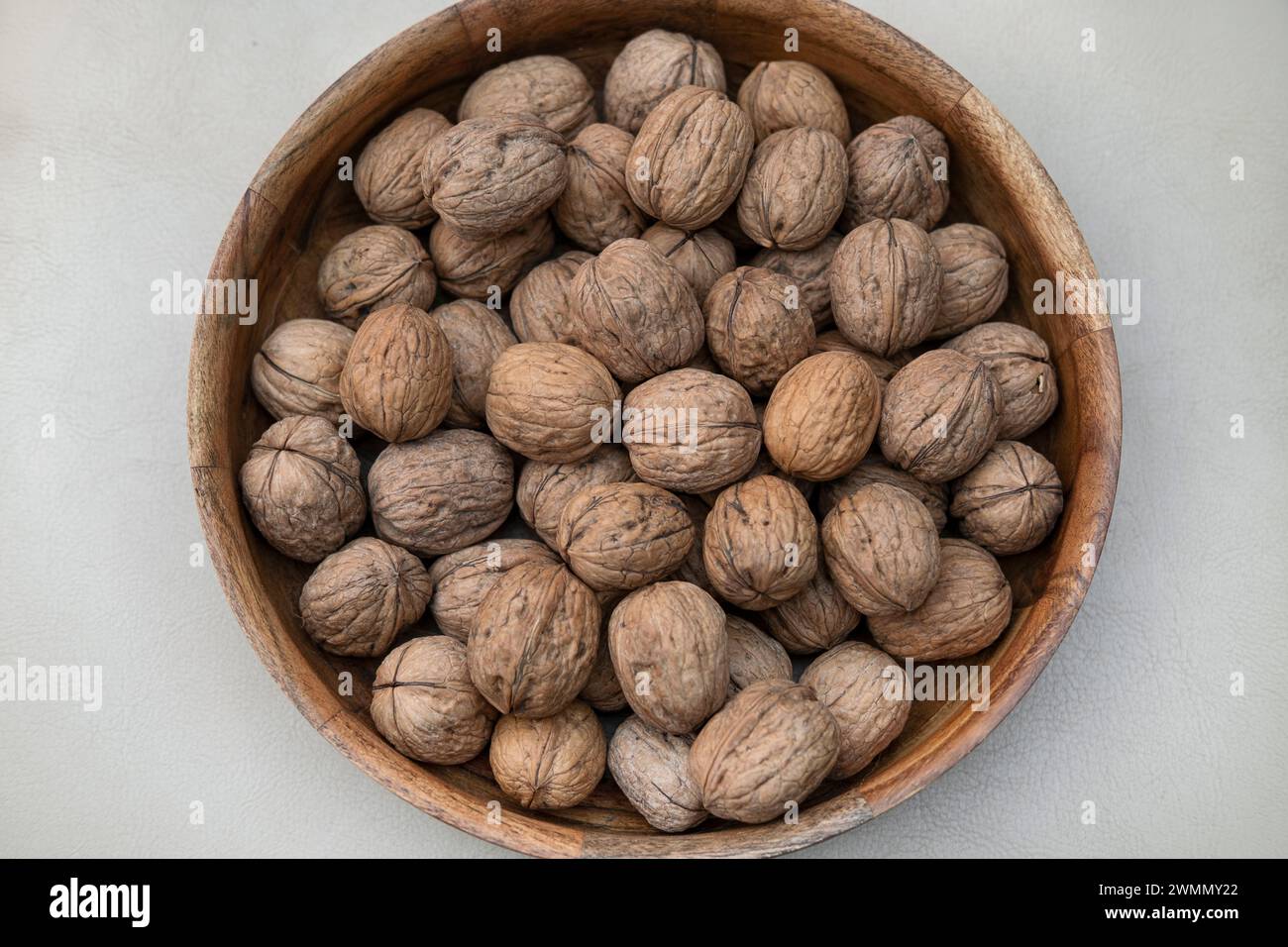 Big wooden bowl of whole walnuts in shells, delicious nutrient-dense ...