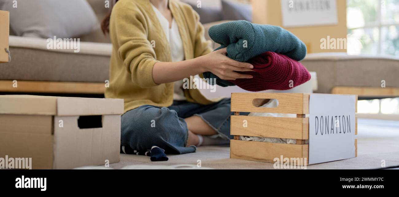 Donation, asian young woman sitting pack object at home, putting on ...