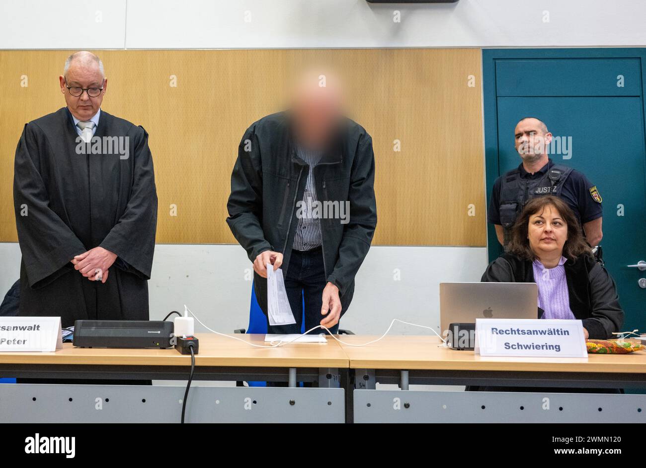 27 February 2024, Rhineland-Palatinate, Trier: The defendant (M) stands ...