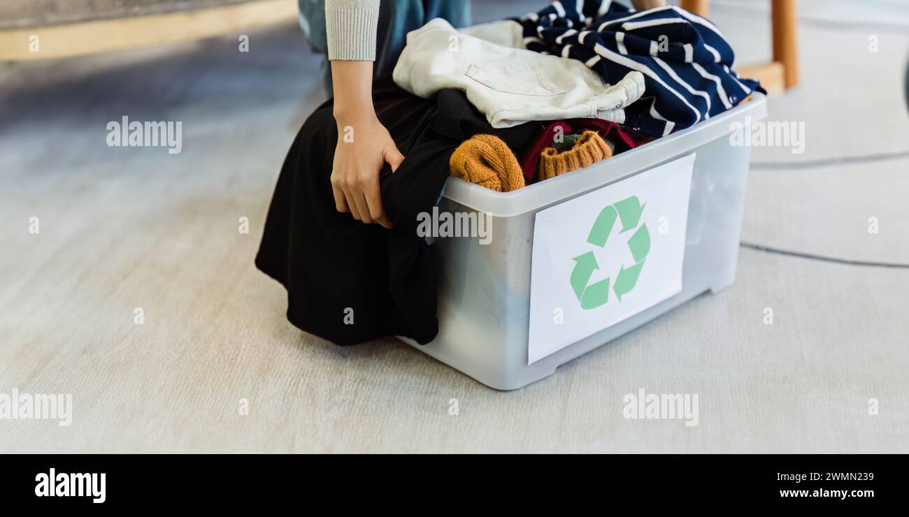 Asian women sort clothes from old clothing box to recycle. Recycling ...