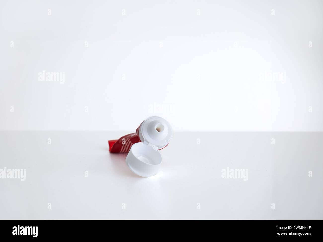 Rolled and squeezed out empty plastic toothpaste tube, isolated on ...