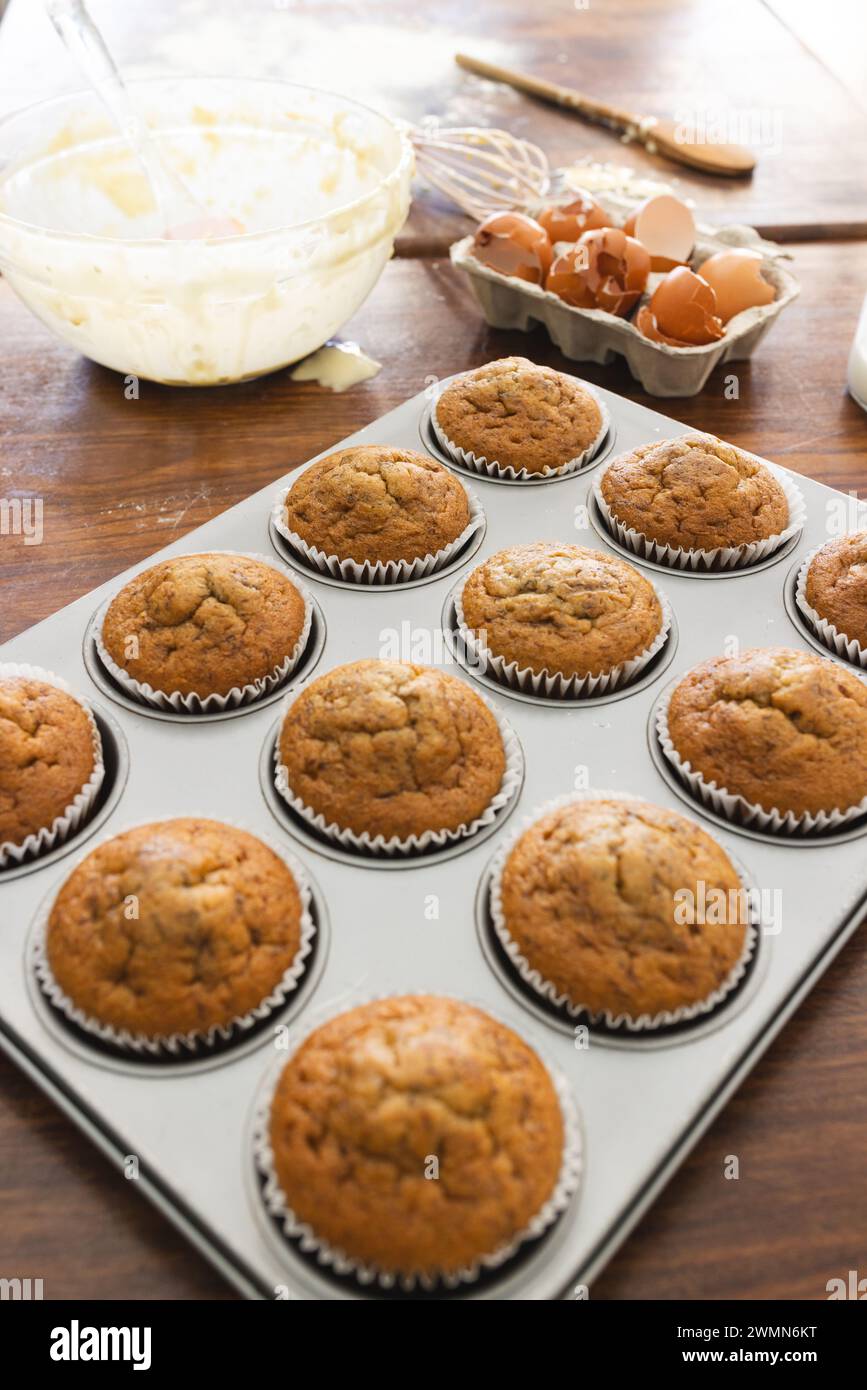 Freshly baked muffins cool on a kitchen counter, with copy space. Home ...