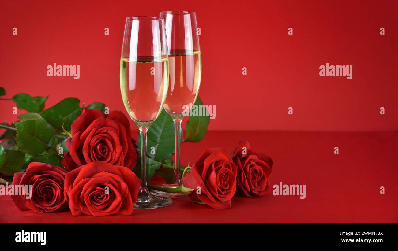 Romantic date night concept. Champagne and roses on a red background ...