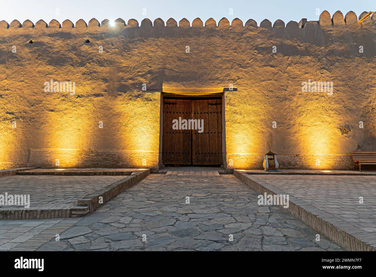 carved wooden door in the wall of a medieval fortification. a carved ...