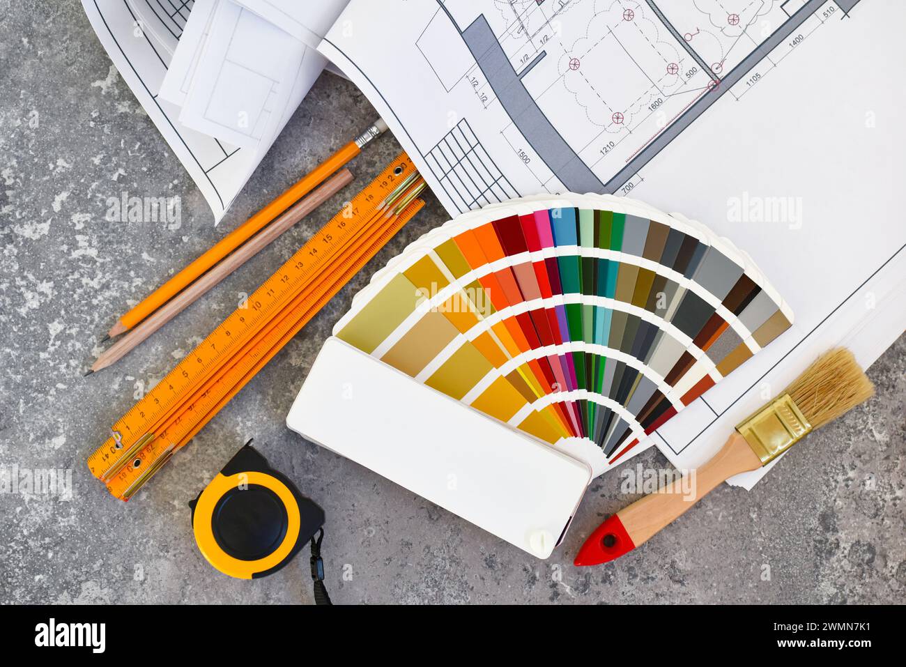 Architectural drawings with color guide, brushes, pencils, ruler on ...