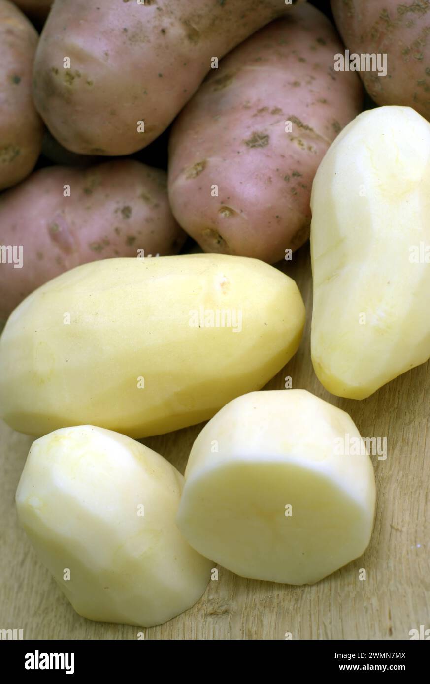 Many peeled potatoes and unpeeled potatoes on kitchen desk in food ...