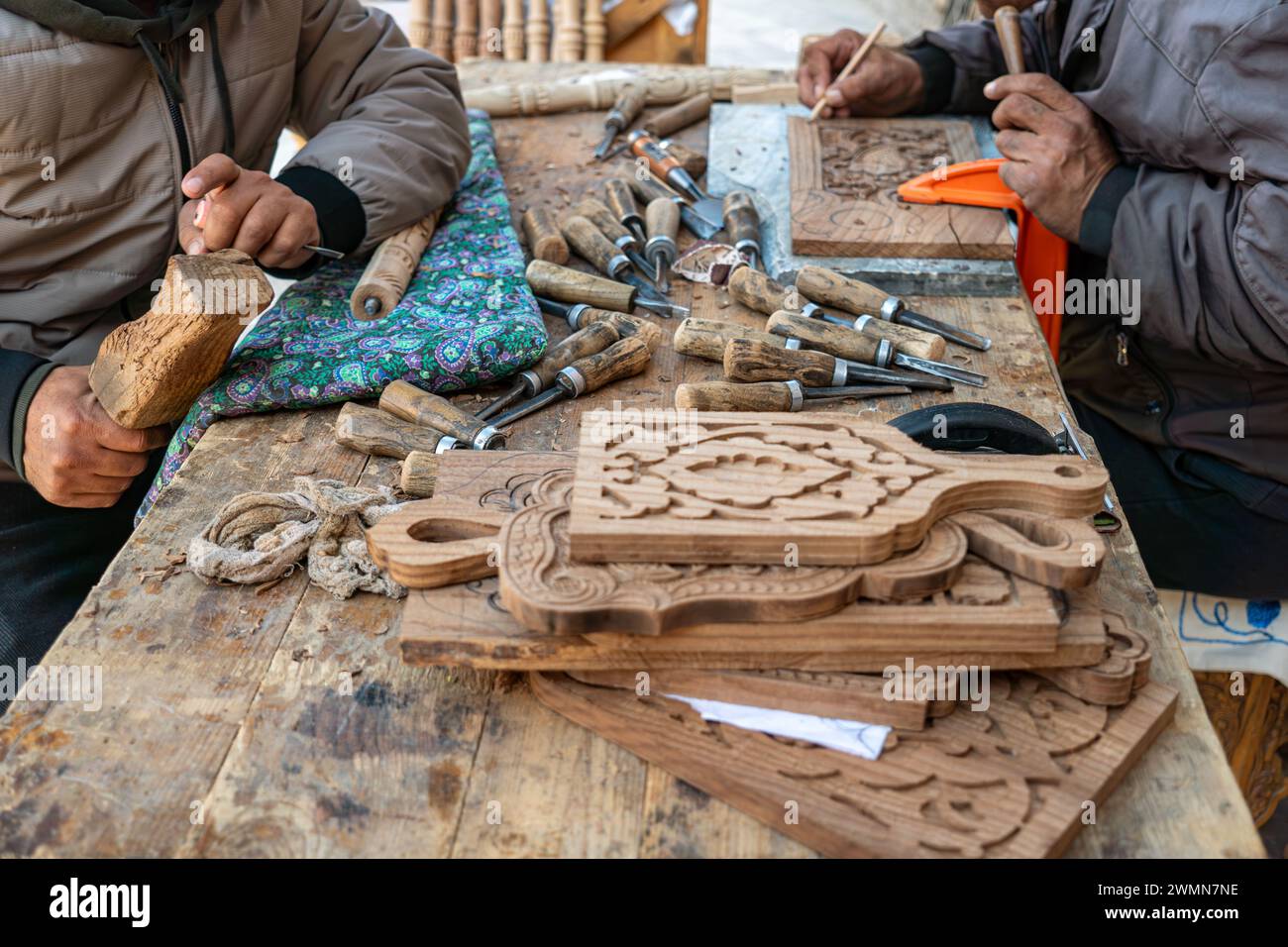 man crafting a wooden cutting board with his hand in Old traditional ...