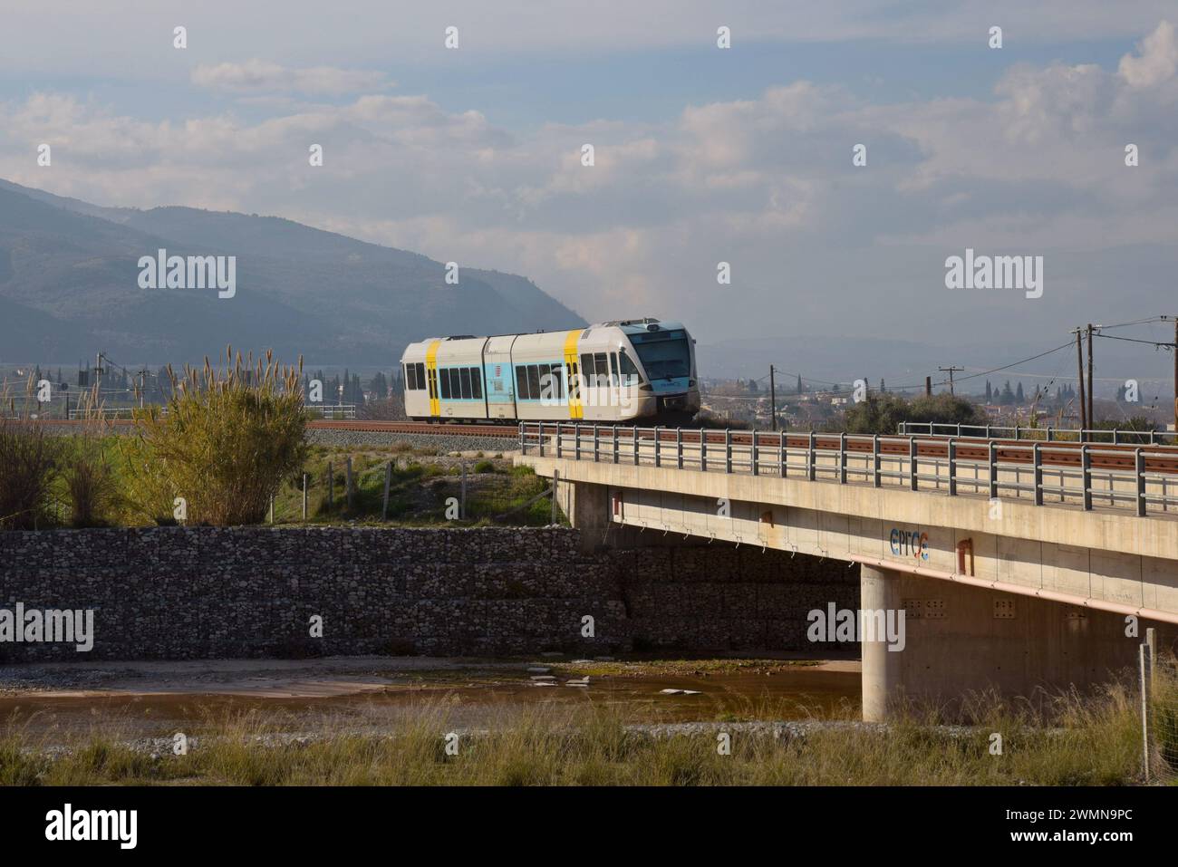 A diesel railcar of the OSE Greek railway leaving the main station in ...