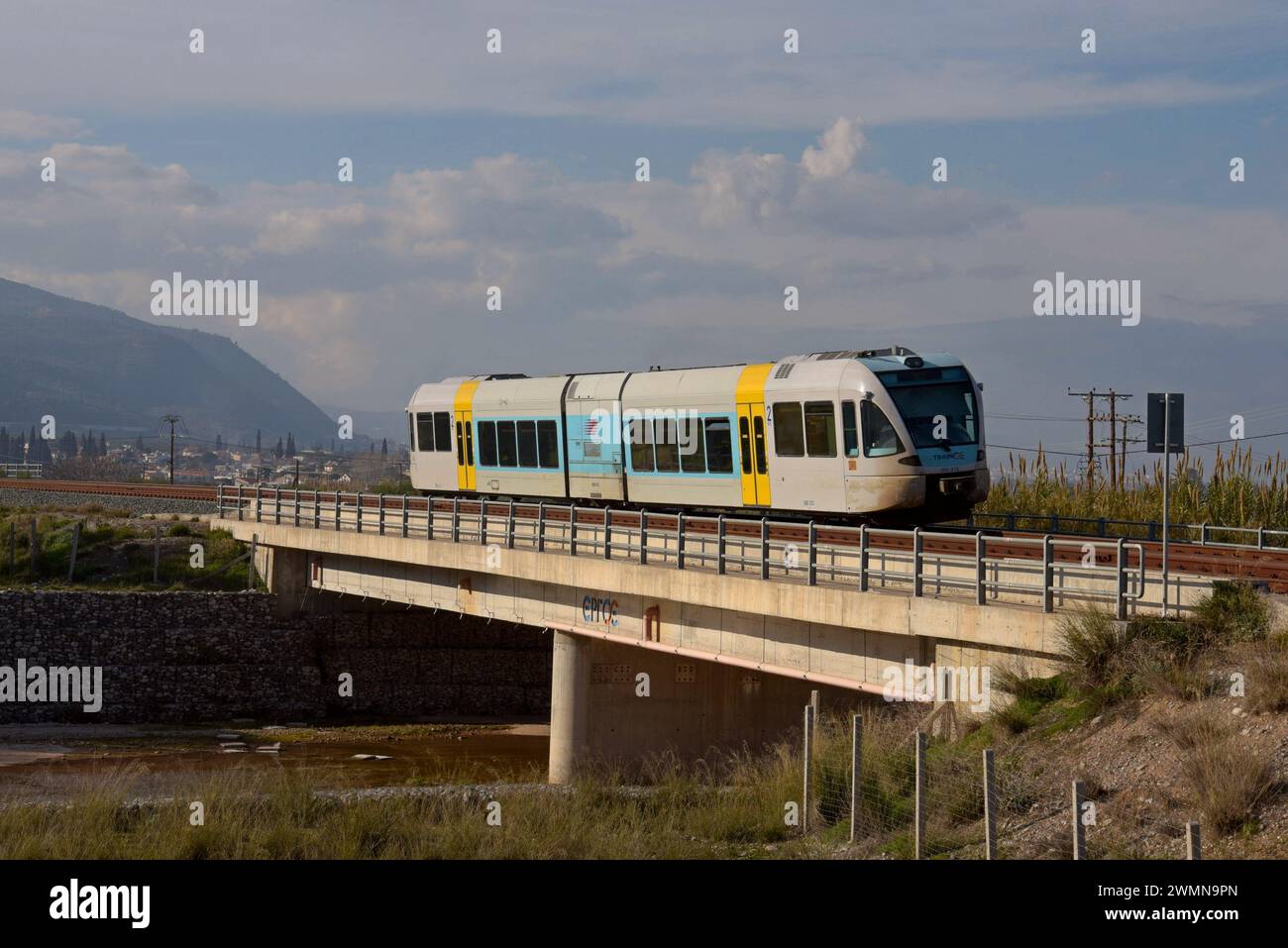 A diesel railcar of the OSE Greek railway leaving the main station in ...