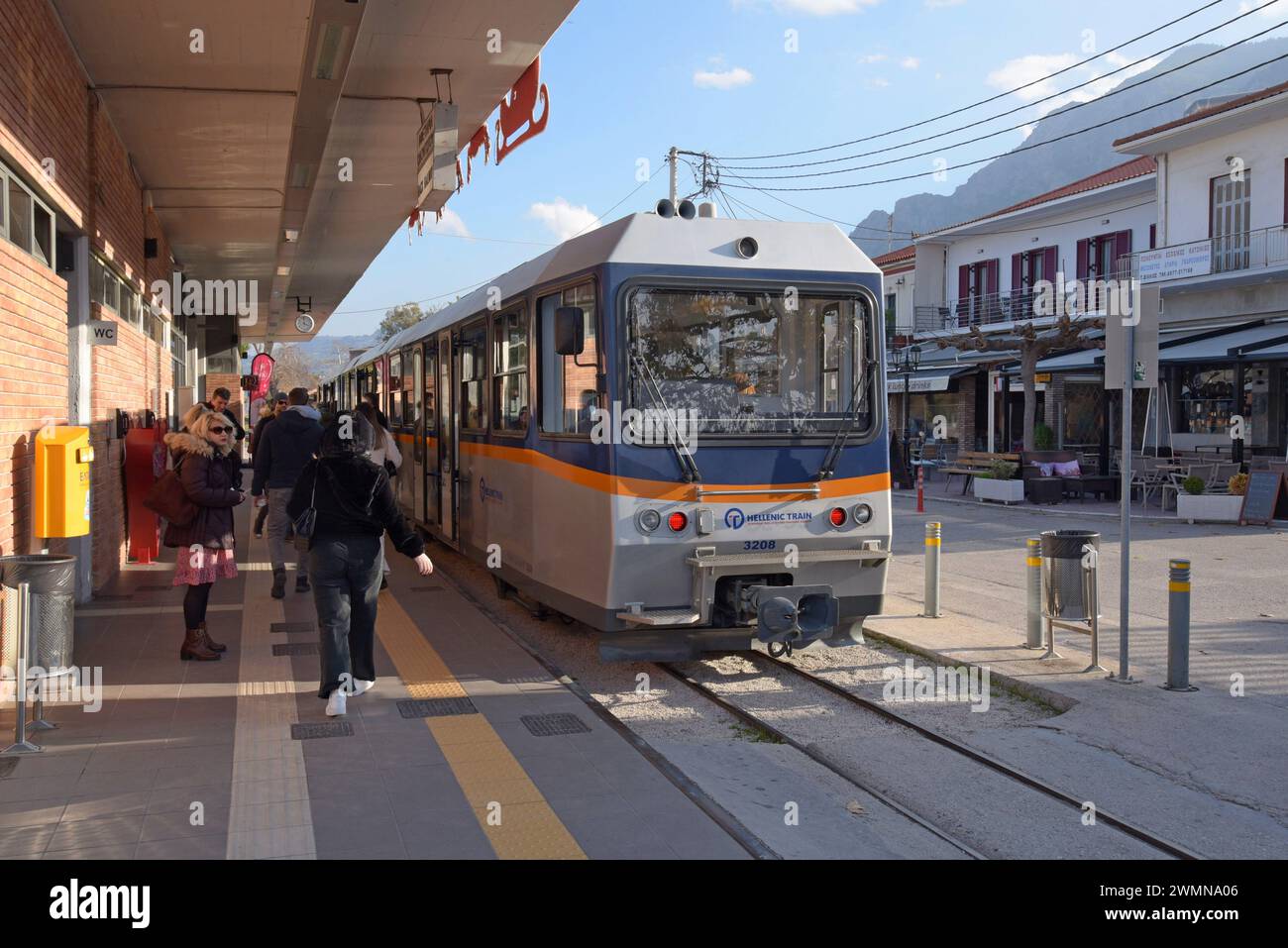 Passengers getting on a diesel railcar of the Diakopto rack railway at ...