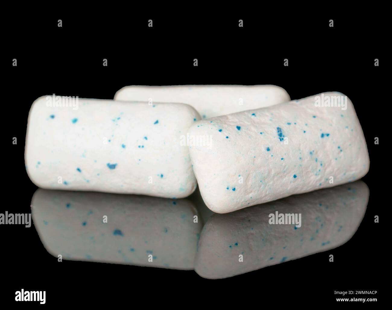 Three chewing gums, macro, isolated on black background Stock Photo - Alamy