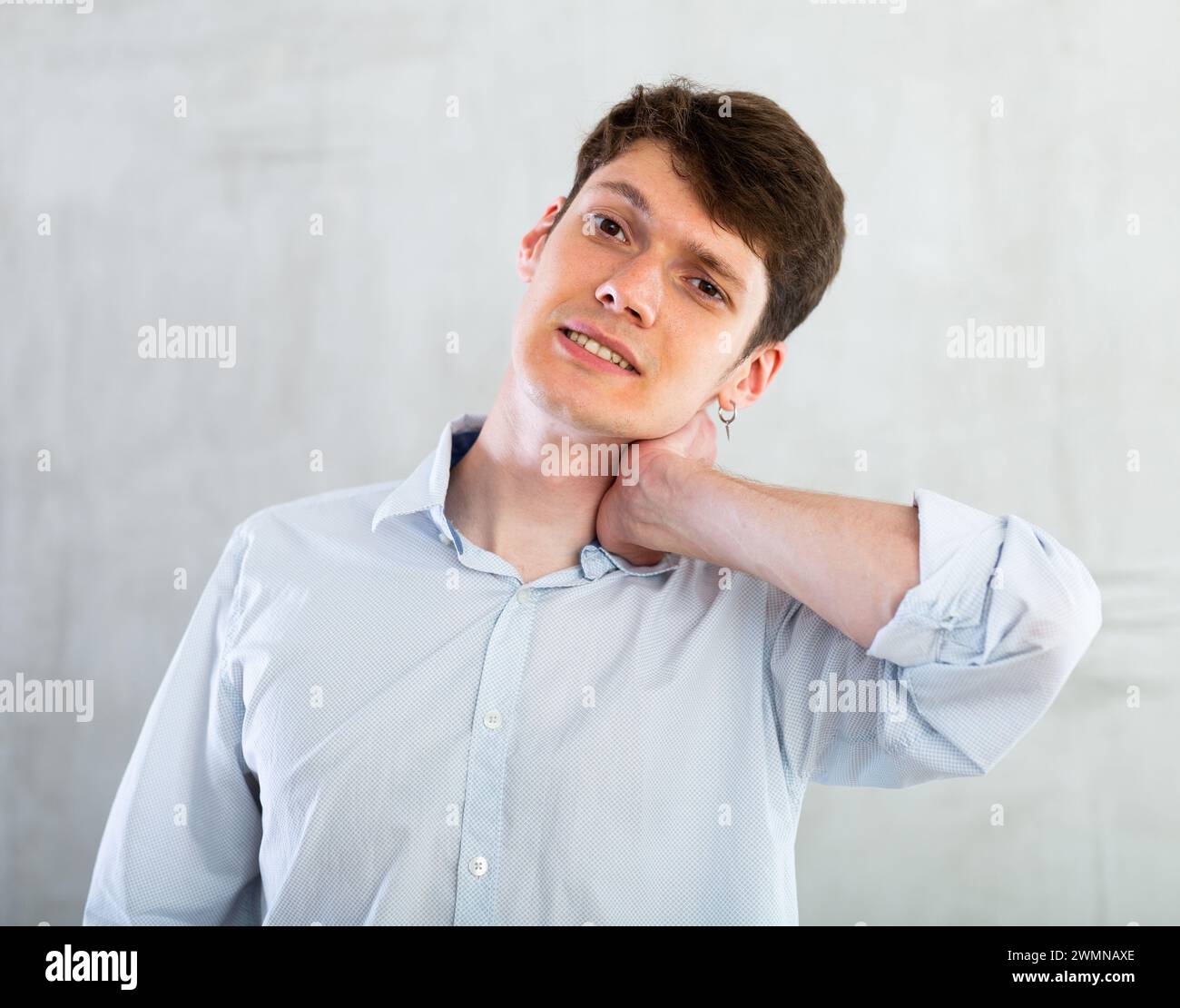 Man experiencing acute pain in his neck Stock Photo - Alamy