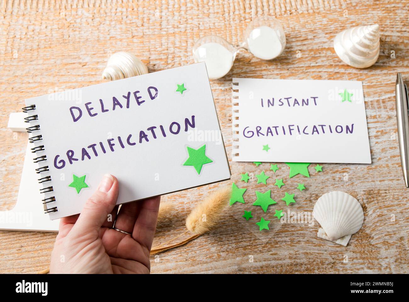 Person hand choosing delayed gratification instead of easy instant ...