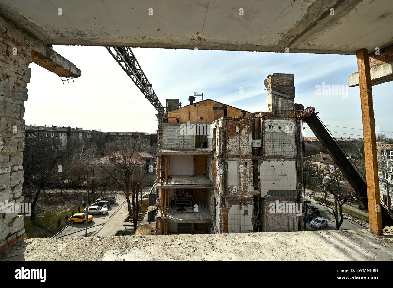 ZAPORIZHZHIA, UKRAINE - FEBRUARY 26, 2024 - Works to rebuild a block of ...