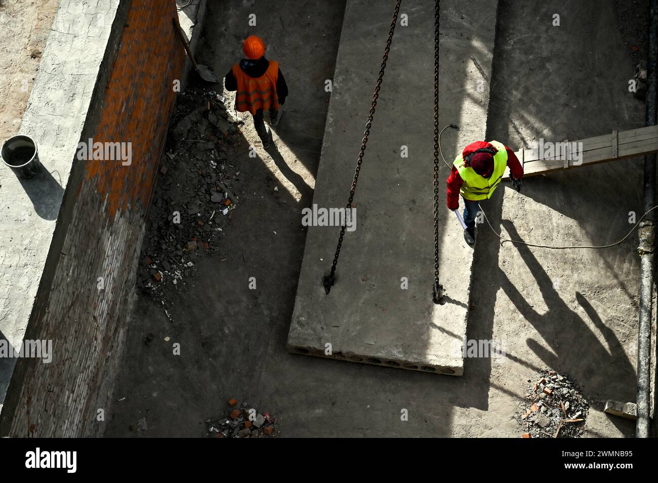 ZAPORIZHZHIA, UKRAINE - FEBRUARY 26, 2024 - Construction workers lay ...