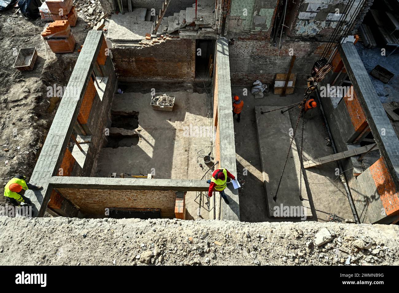 ZAPORIZHZHIA, UKRAINE - FEBRUARY 26, 2024 - Construction workers lay ...