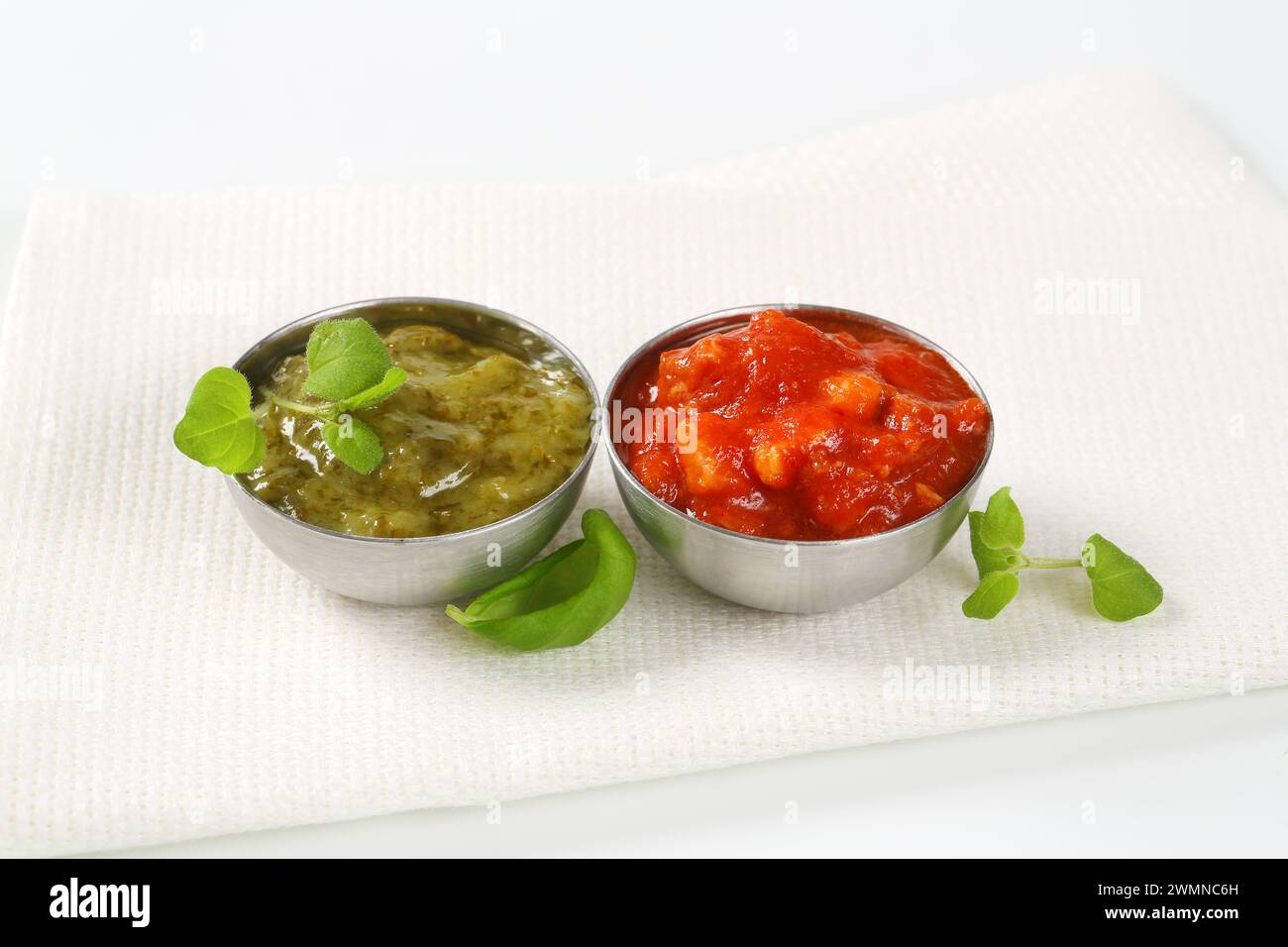 Basil pesto and tomato salsa in metal bowls Stock Photo - Alamy