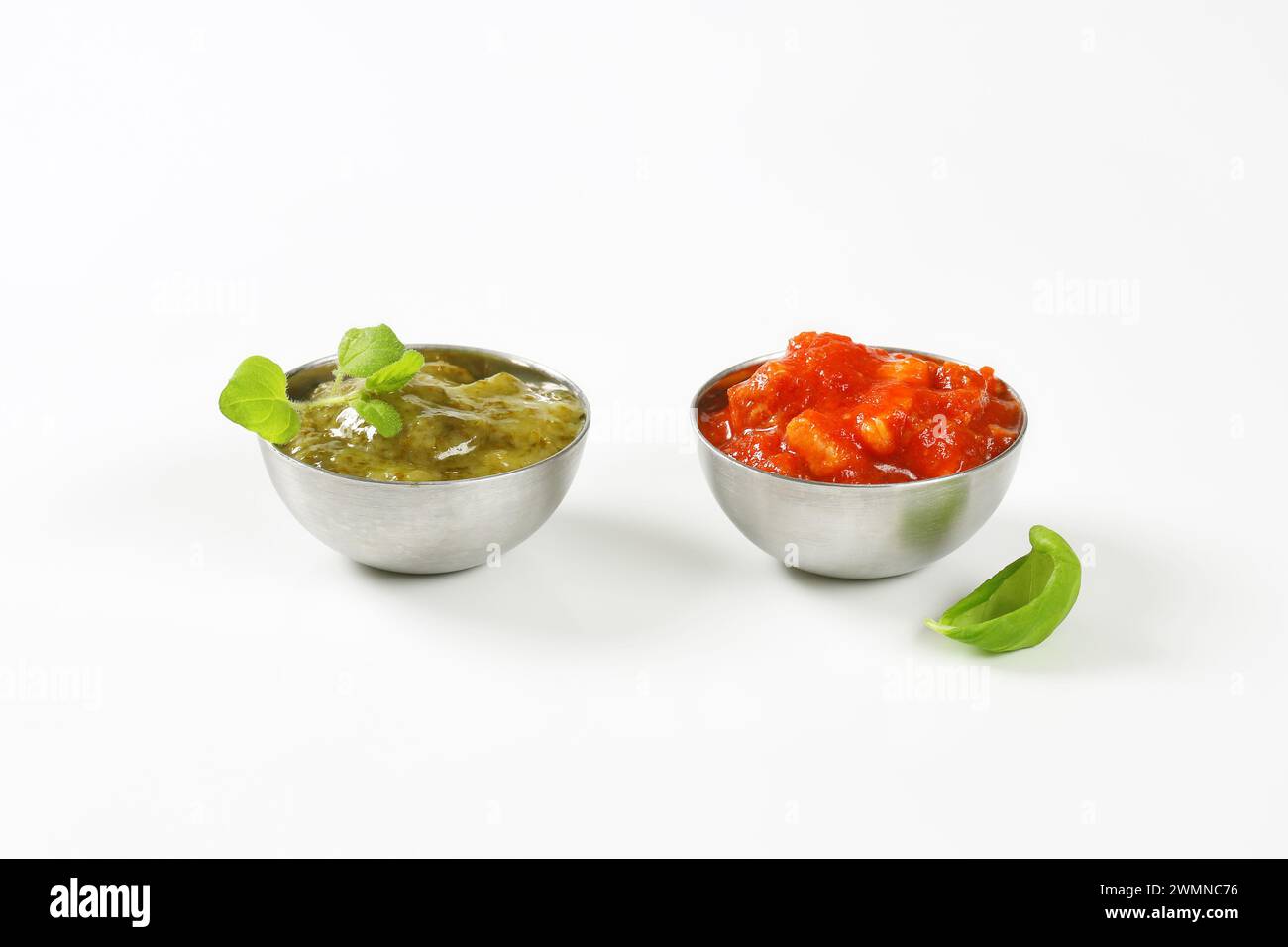 Basil pesto and tomato salsa in metal bowls Stock Photo - Alamy