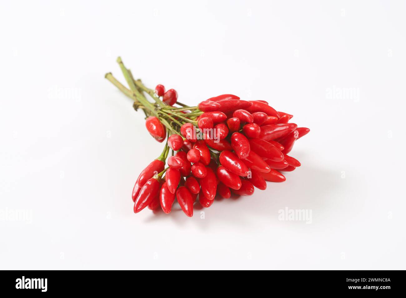 Bunch of small red chili peppers on white background Stock Photo - Alamy